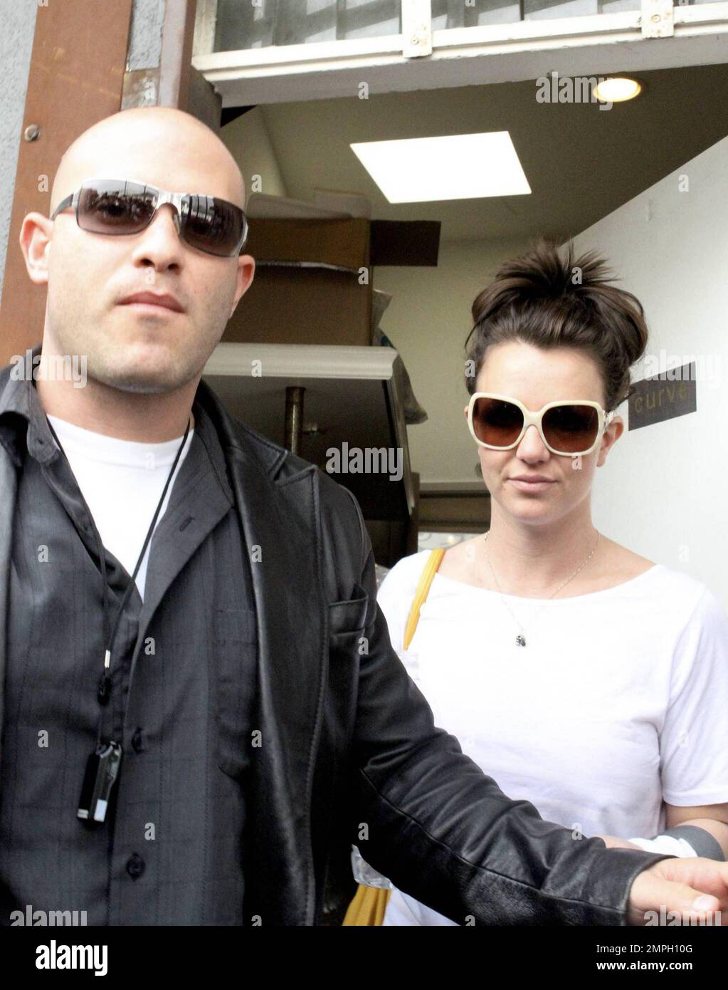 Accompanied by a bodyguard, Britney Spears wears a ring on her ...