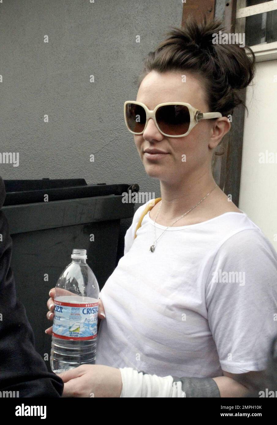 Accompanied by a bodyguard, Britney Spears wears a ring on her ...