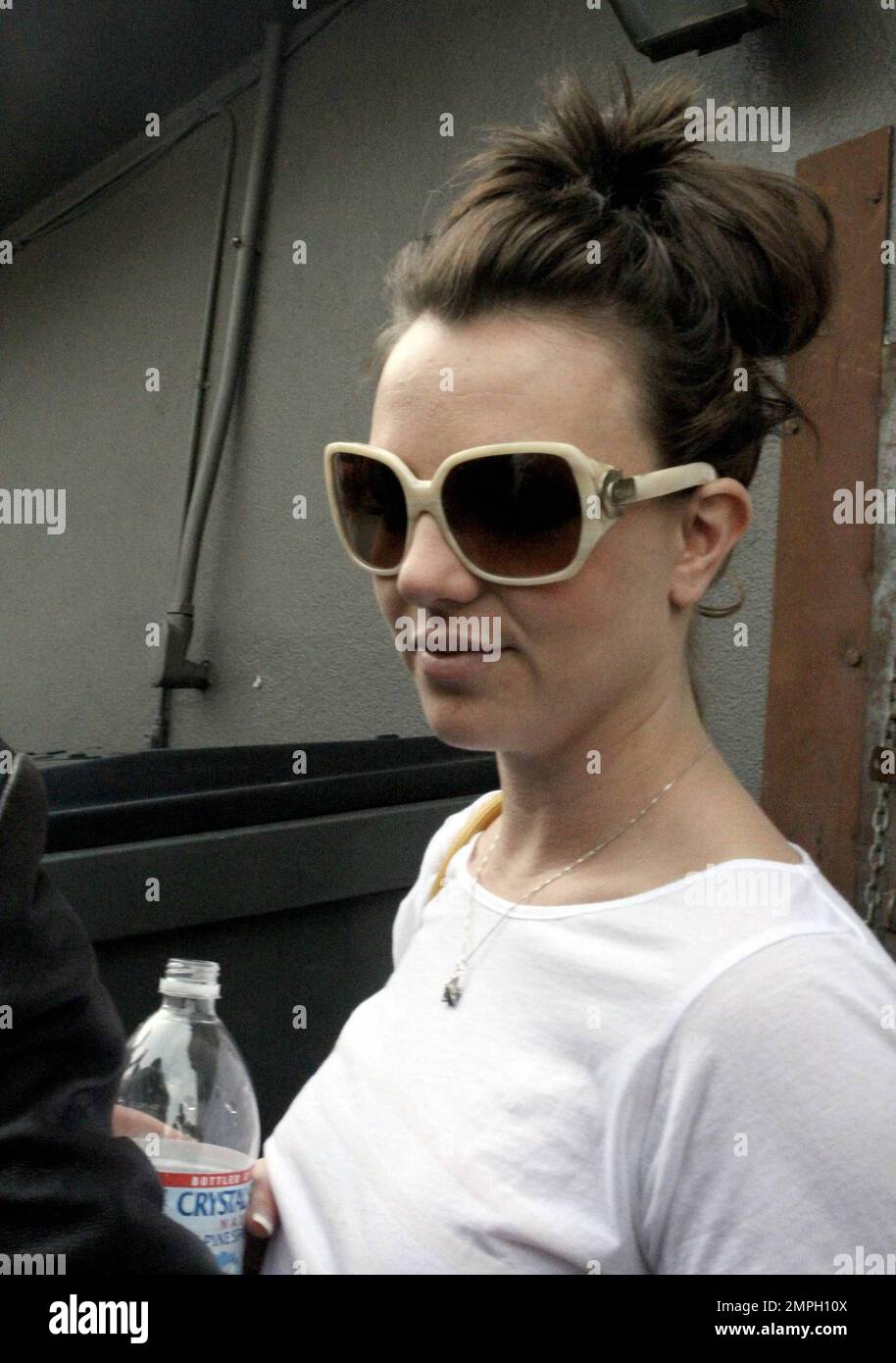 Accompanied by a bodyguard, Britney Spears wears a ring on her ...