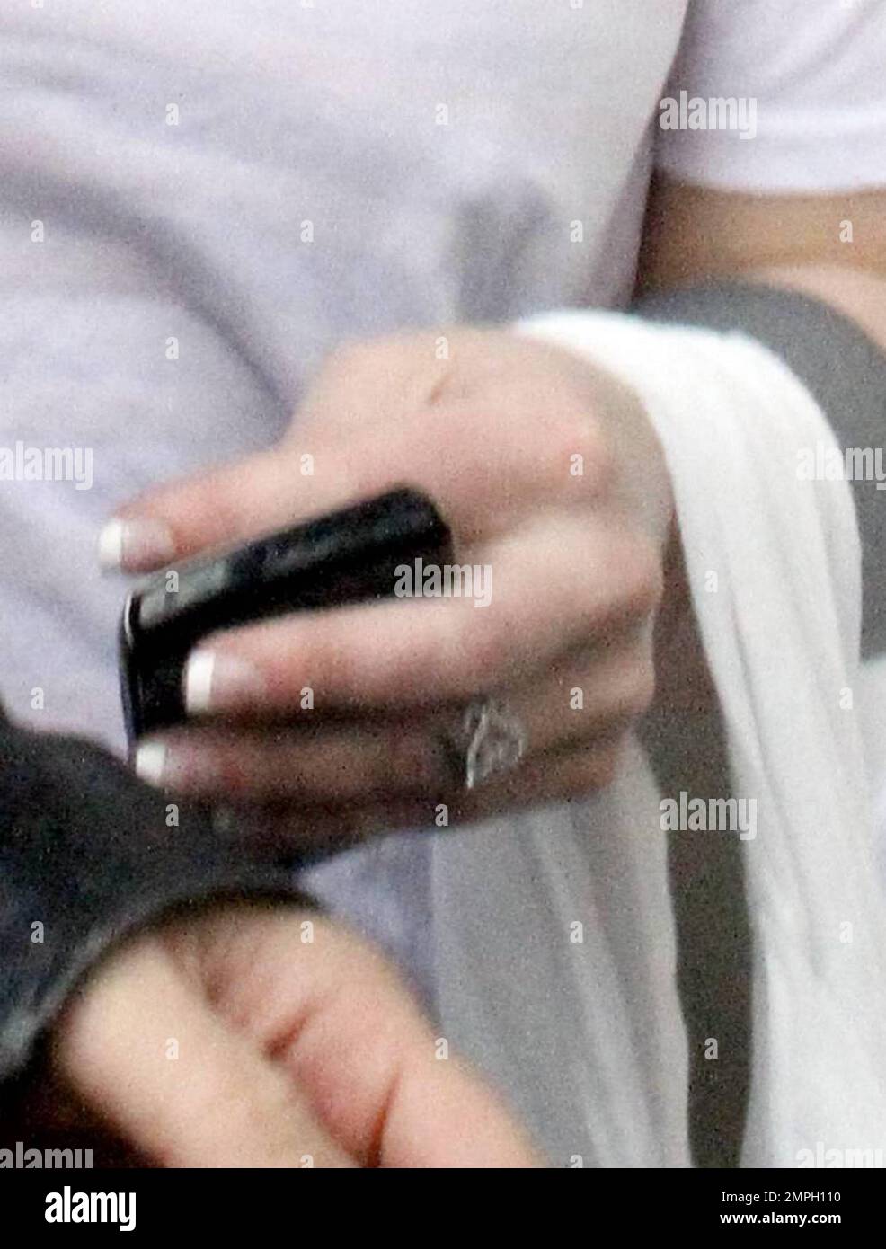 Accompanied by a bodyguard, Britney Spears wears a ring on her ...