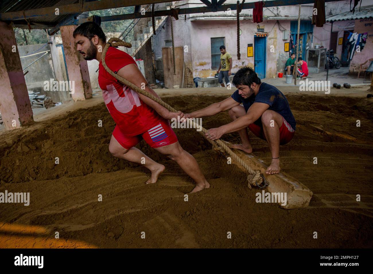 In this Nov. 20, 2017 photo, Indian kushti wrestlers prepare the ground ...