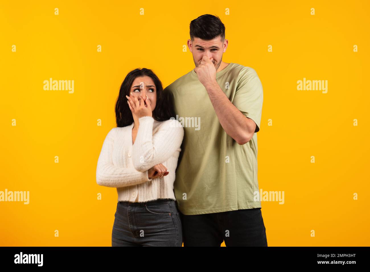 Sad dissatisfied young arabic woman and guy in casual cover nose with ...