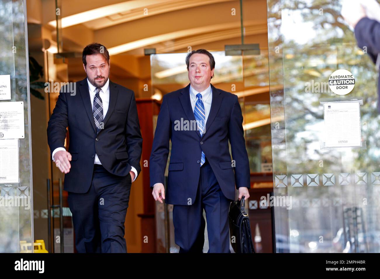 Jordan Hamlett, left, leaves federal court with his attorney Michael ...