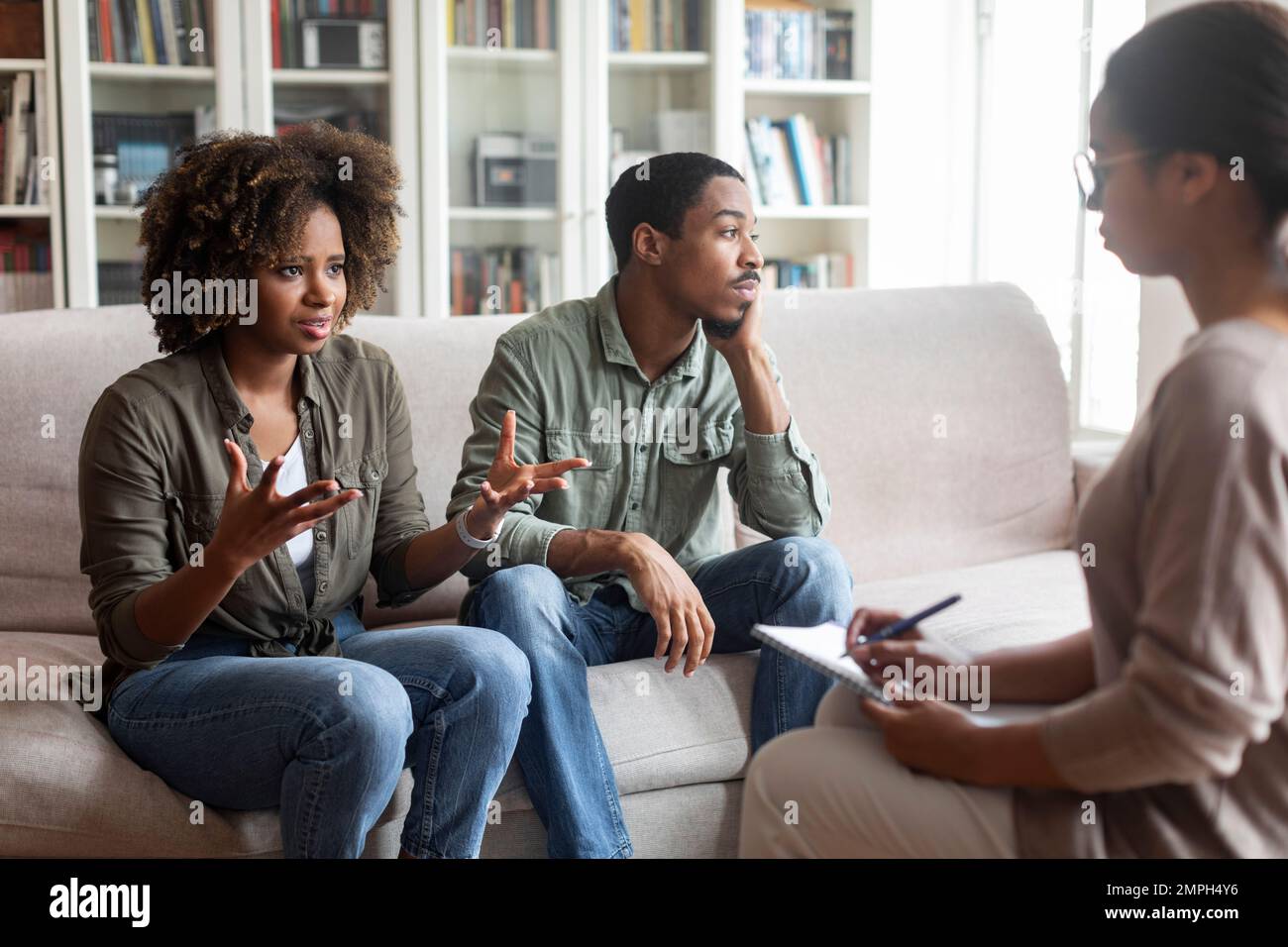 Young black woman sharing thoughts with psychologist during family ...