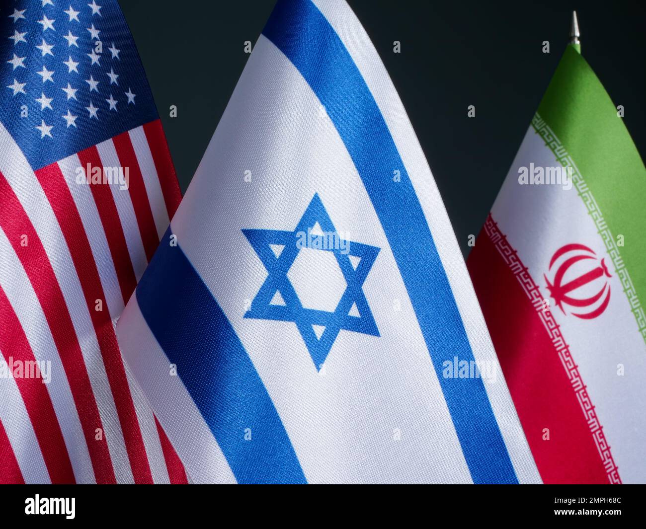 Near the flags of the USA and Israel, the flag of Iran in the distance ...