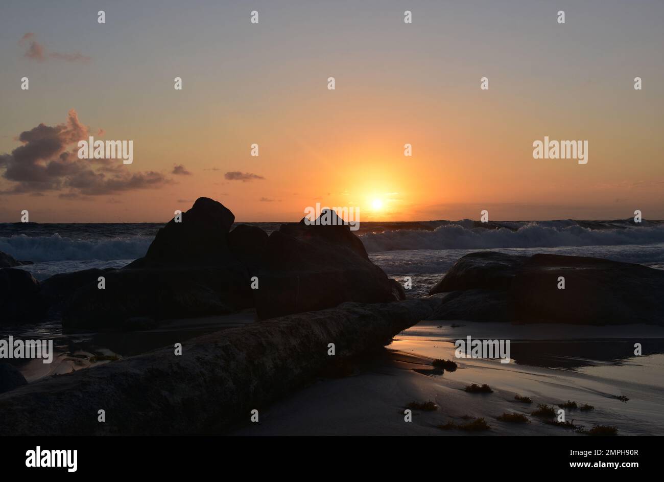 Gorgeous orange sunrise at dawn on a beach in Aruba Stock Photo - Alamy