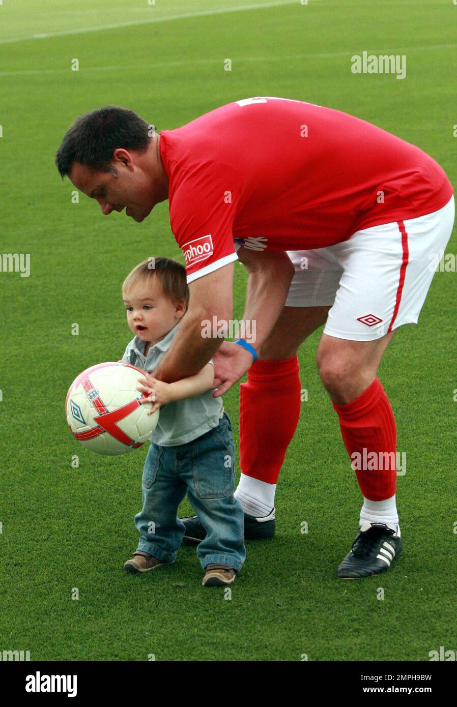 Eric Wynalda plays with his son at halftime at the BritWeek 2010 ...