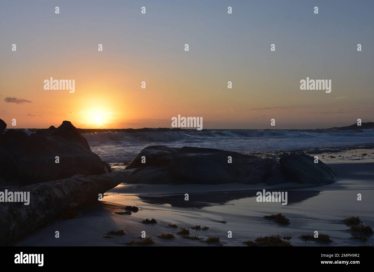 Scenic seascape with the sun rising over the ocean in Aruba Stock Photo ...