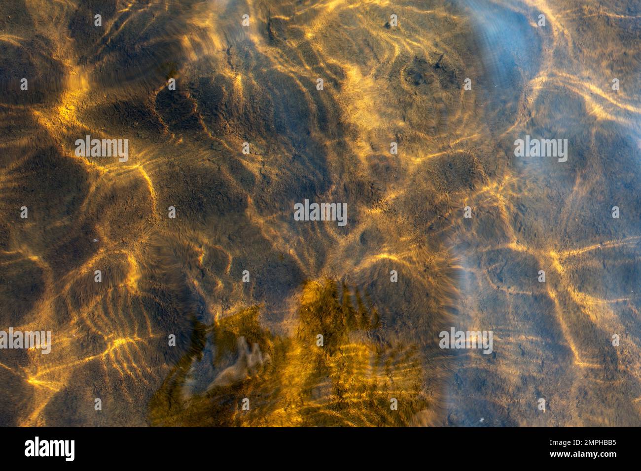 The background is natural. Reflection of sunlight from the waves of ...