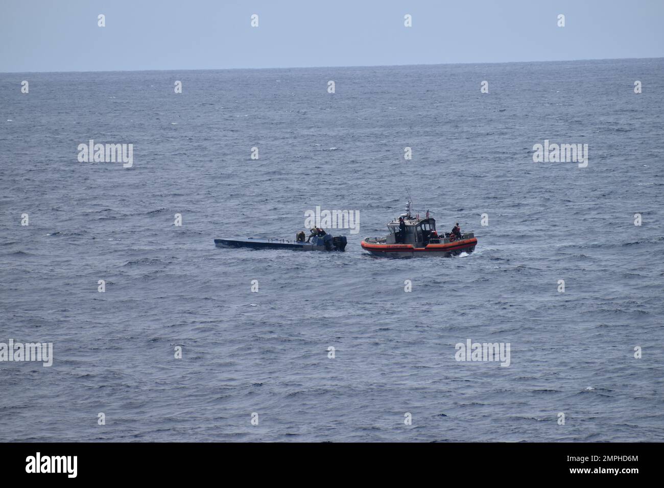 A U.S. Coast Guard Cutter Bertholf (WMSL 750) boarding team approach a ...