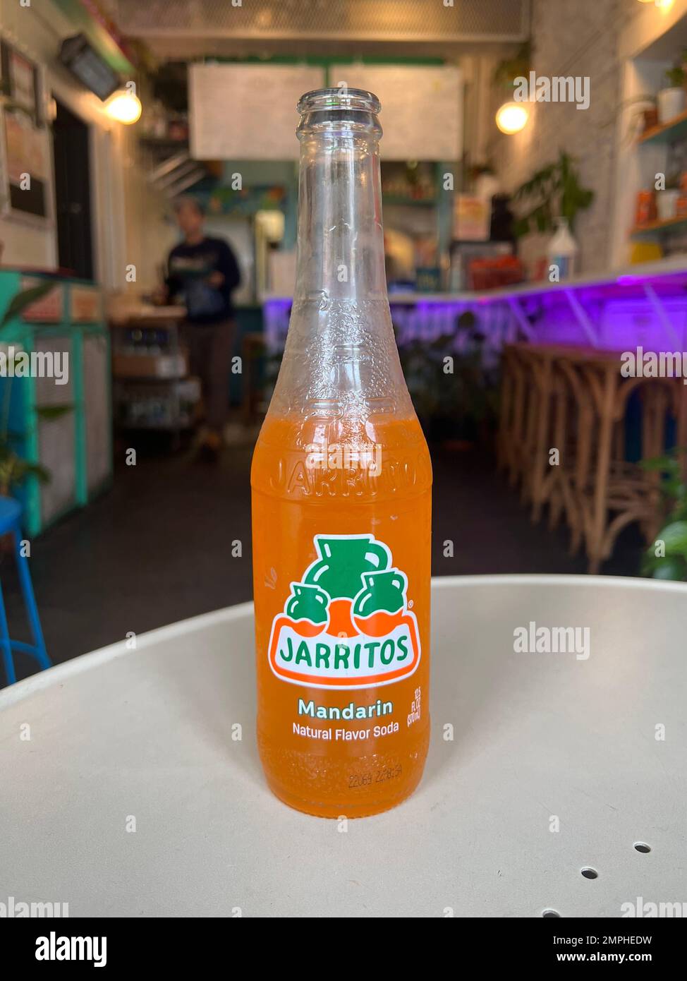 A vertical shot of a bottle of a Mexican Jarritos drink in the ...