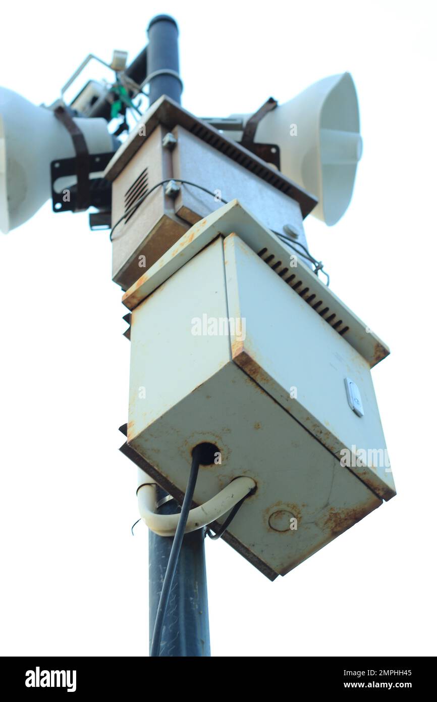 A vertical shot of an outdoor warning siren attached to a pole, a view ...