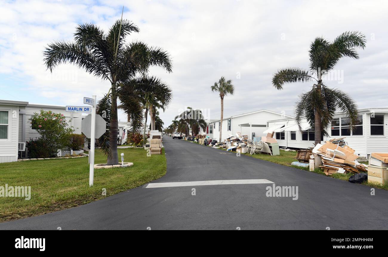 Naples, FL, USA--10/24/2022--Debris is piled up outside of homes ...