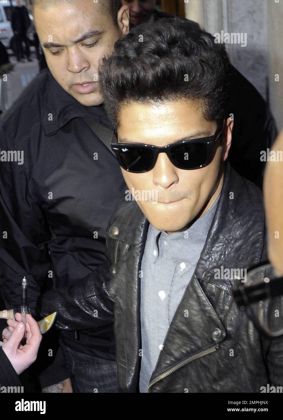 Singer/songwriter Bruno Mars (aka Peter Gene Hernandez) is mobbed by fans and photographers as ...