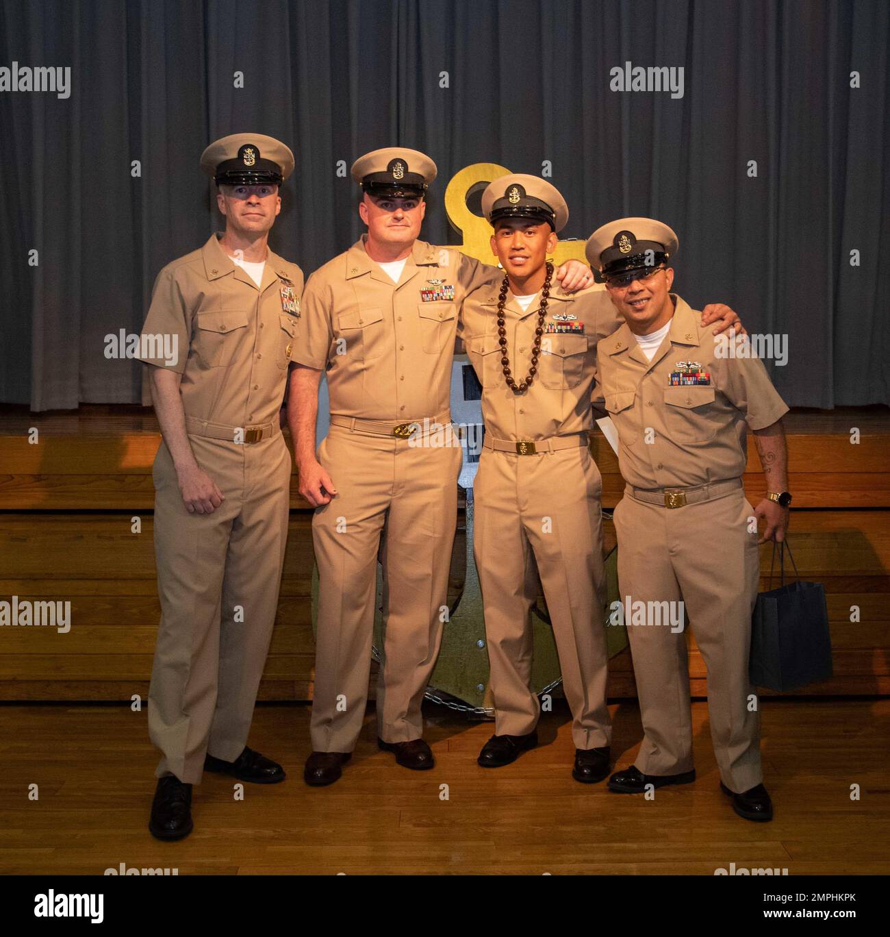 Sailors pose for a photo following a chief petty officer pinning ...