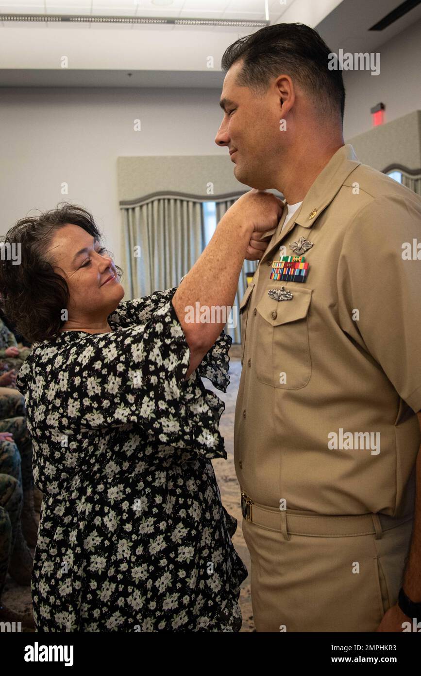 Chief Petty Officer Peter Austin receives his new rank from his wife ...