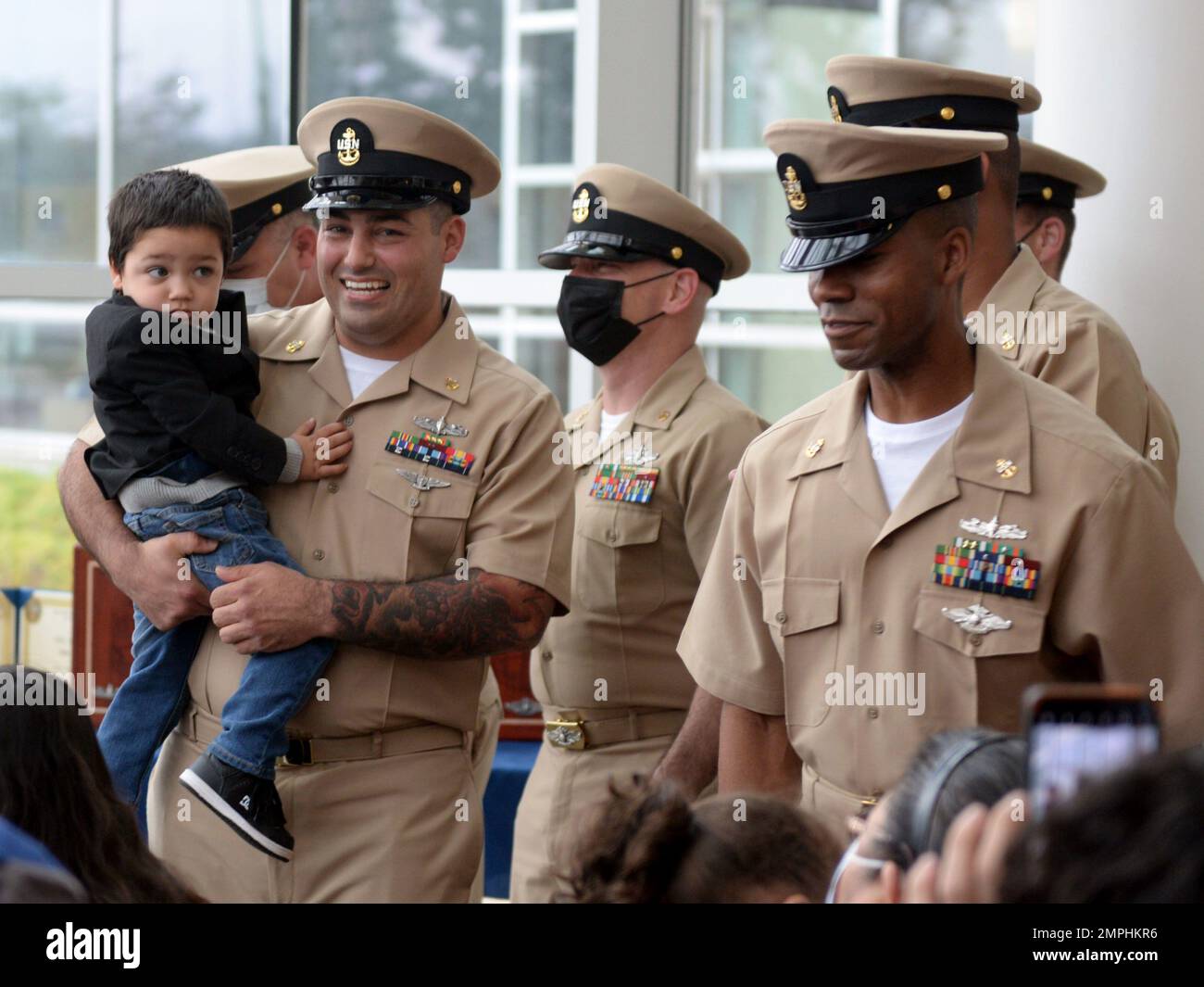 With his hands full...Chief Gunner’s Mate Tristan Brayman hoists his ...