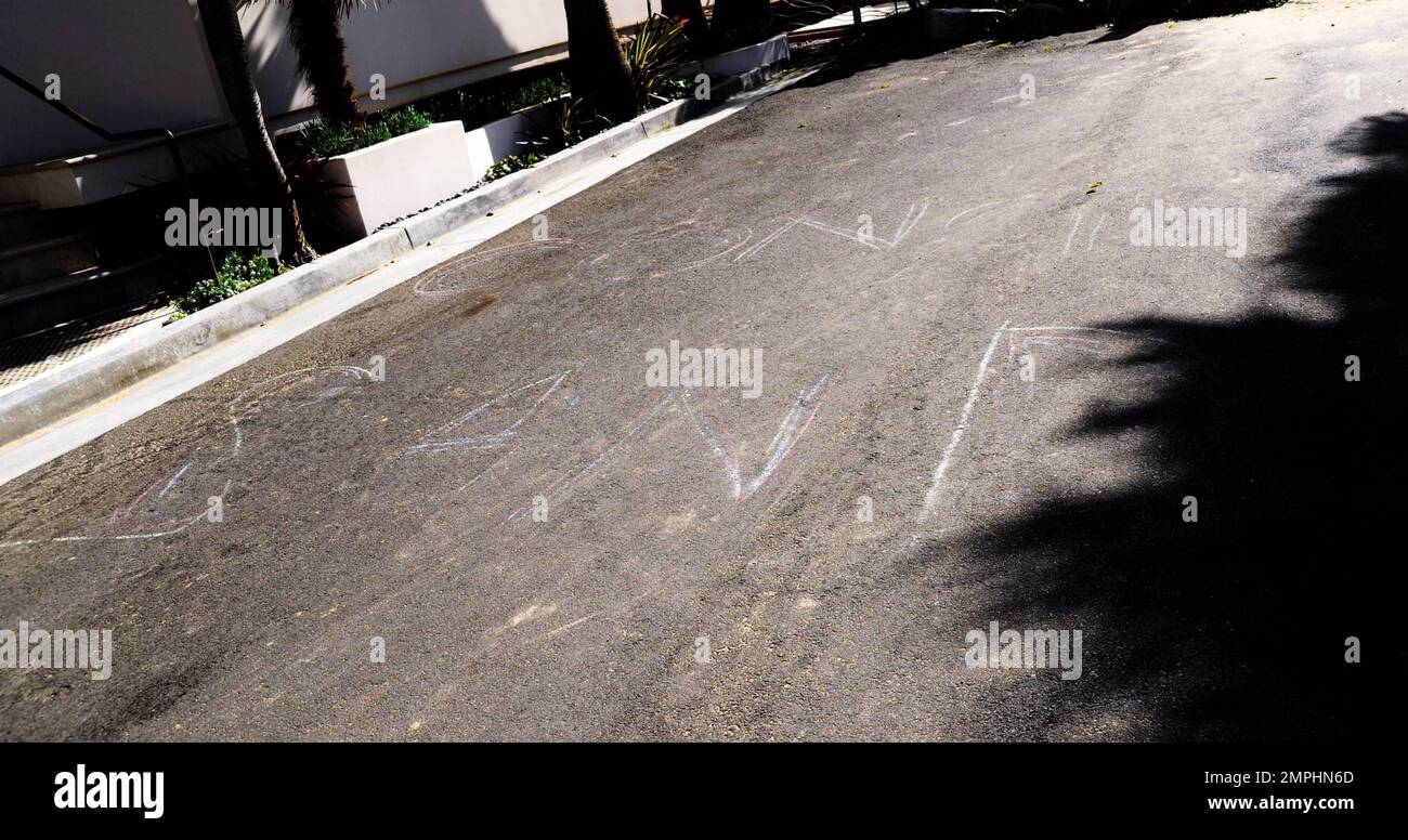 The faded remnants of "CONGRATULATIONS SANDRA" message in chalk outside ...