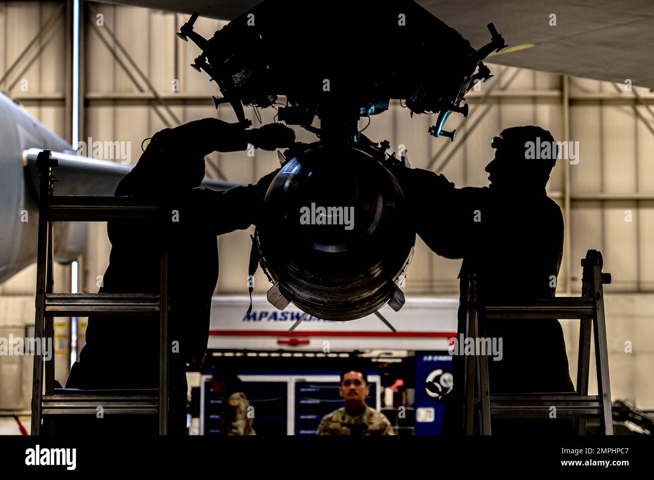 A team from the 5th Aircraft Maintenance Squadron prepares to load a ...