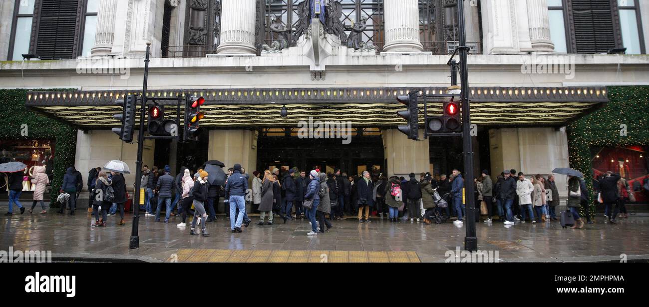 Shoppers queue outside a large department store on Oxford Street in ...