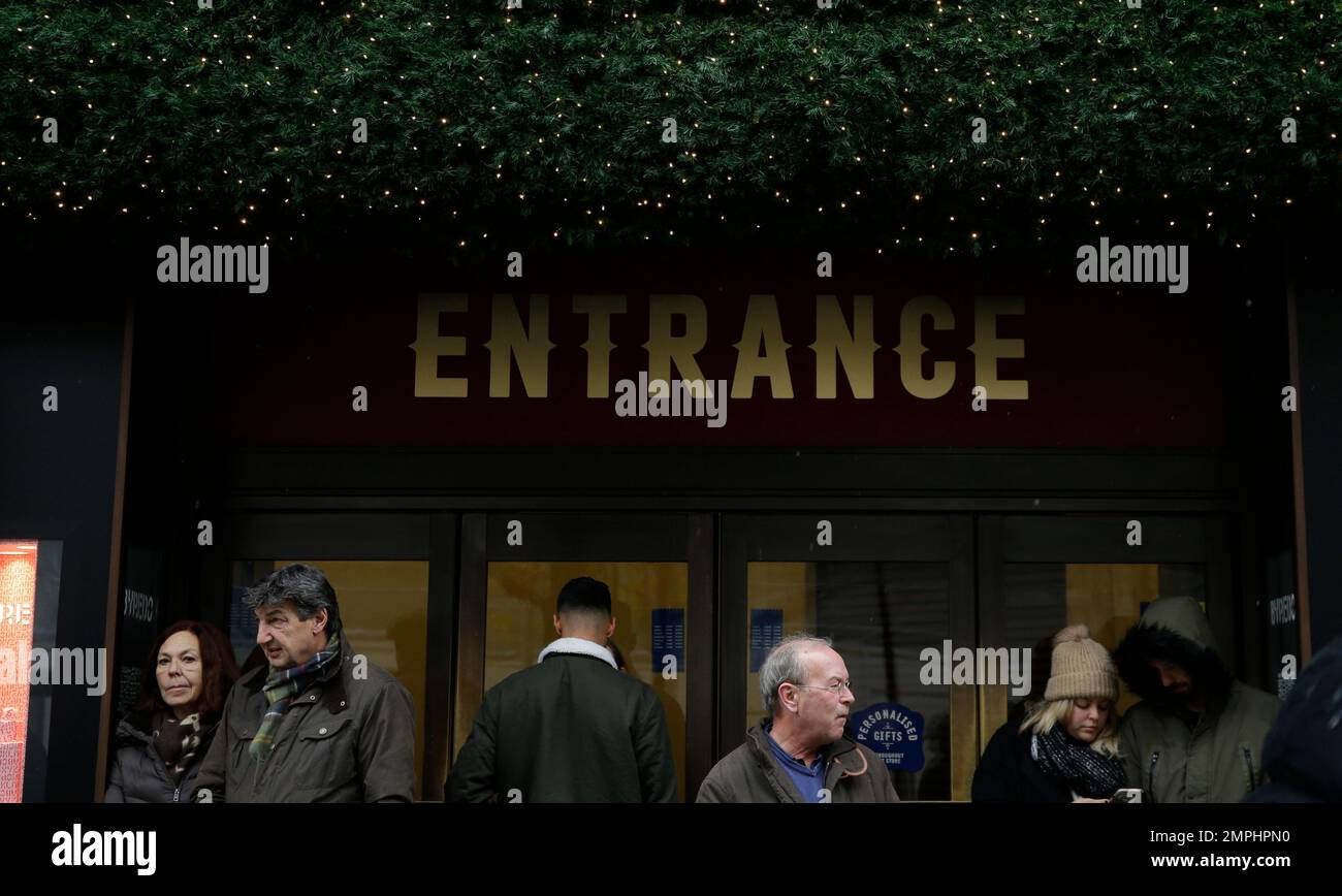 Shoppers queue outside a large department store on Oxford Street in ...