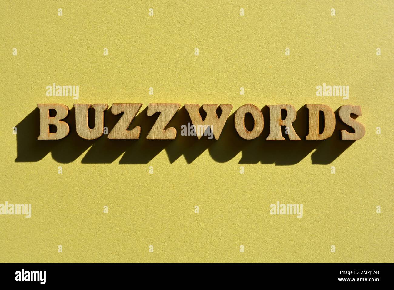 Buzzwords, word in wooden alphabet letters isolated on yellow ...