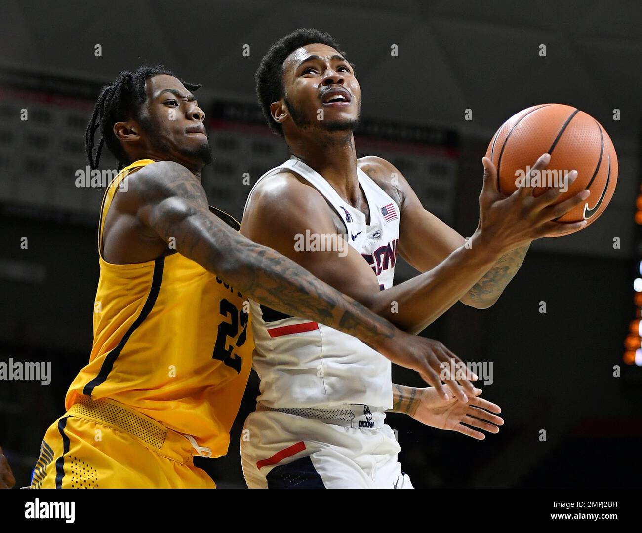 Connecticut's Jalen Adams is fouled by Coppin State's LamarMorgan, left ...