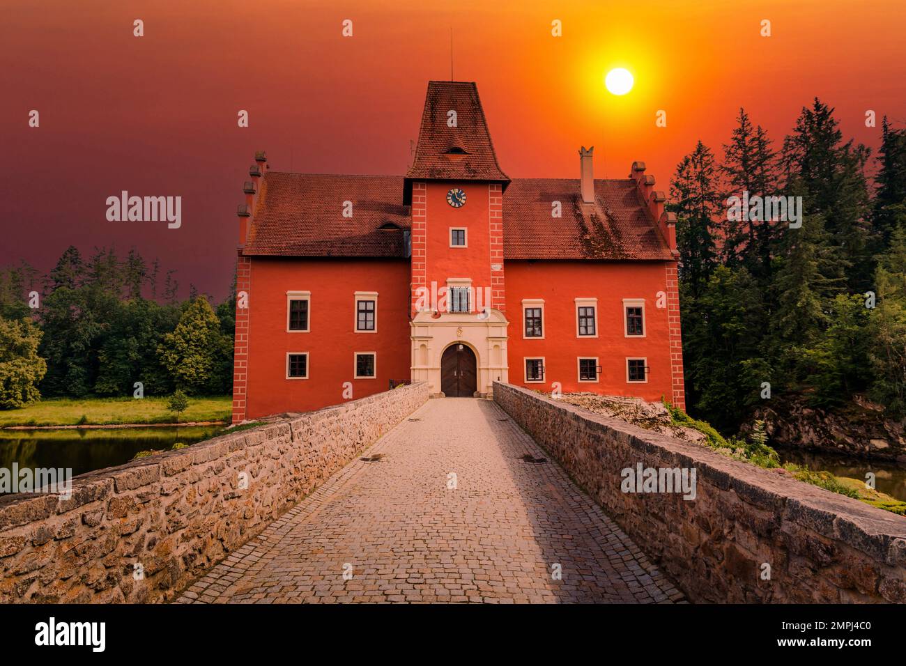 Fairy tale red castle Cervena Lhota on the lake with bridge, with ...