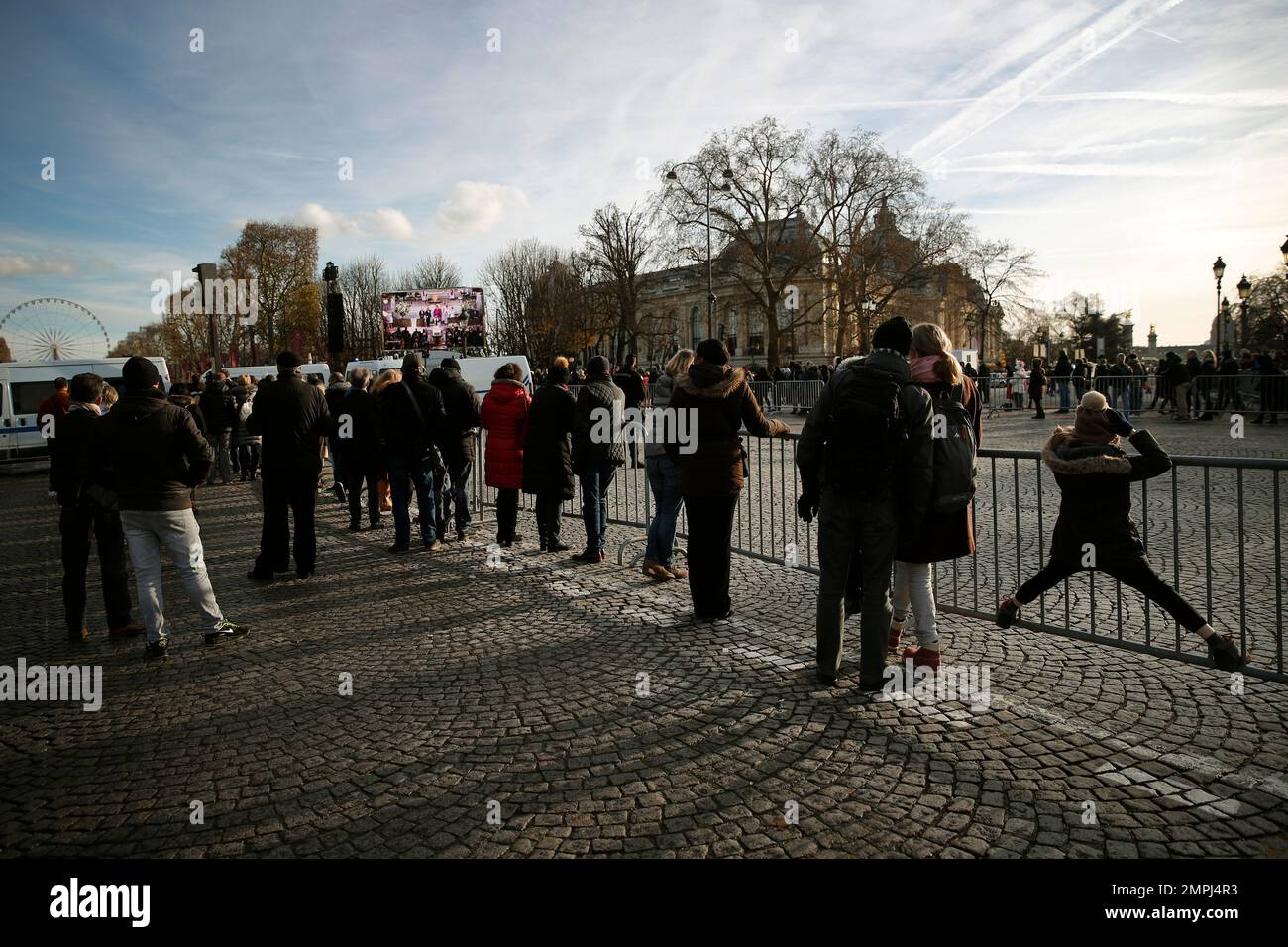 Fans watch on a giant screen French rock star Johnny Hallyday's funeral ...