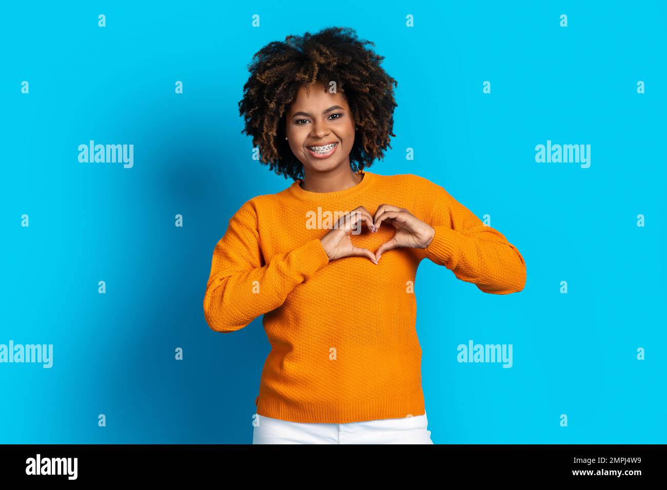 Beautiful african american woman showing heart hand over chest Stock ...