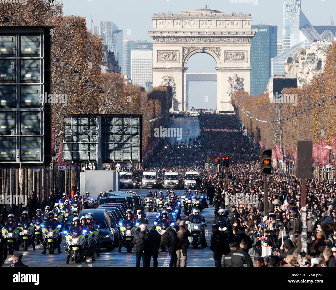 A motorcycle parade follows the hearse carrying the casket of French ...