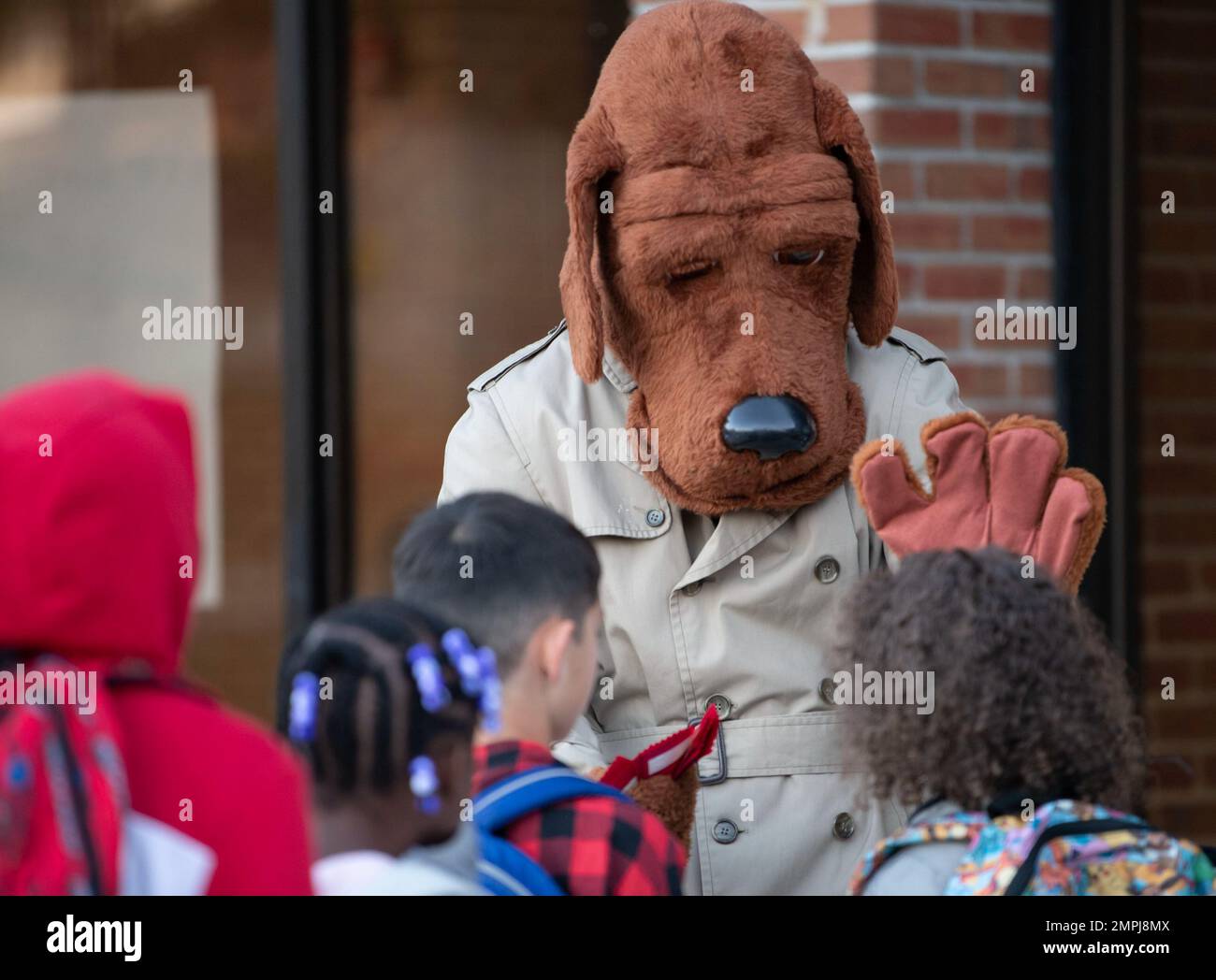 McGruff the Crime Dog hands out red ribbons to students as they enter C ...