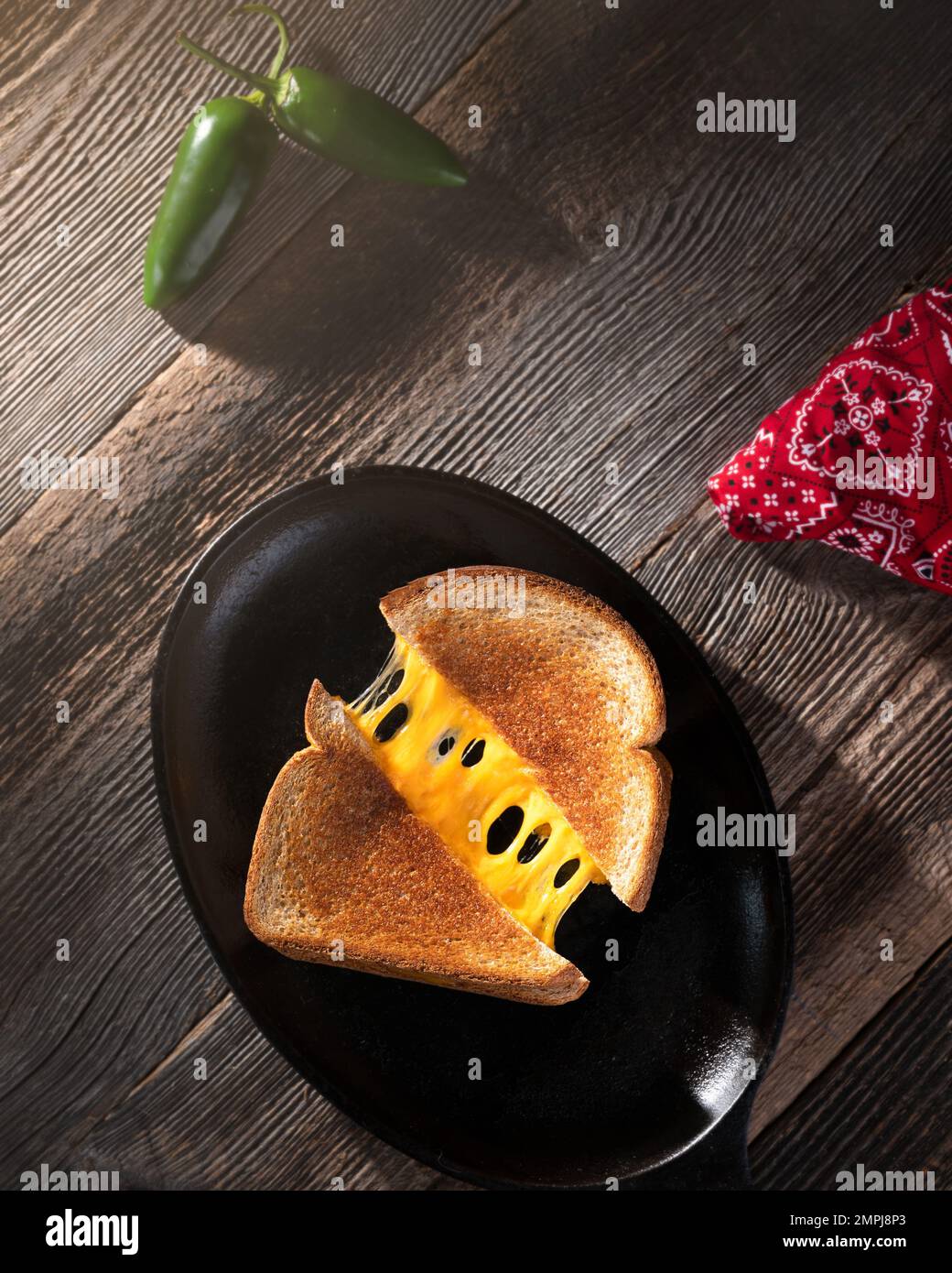 Grilled cheese freshly made on a cast iron skillet with a cheese pull ...