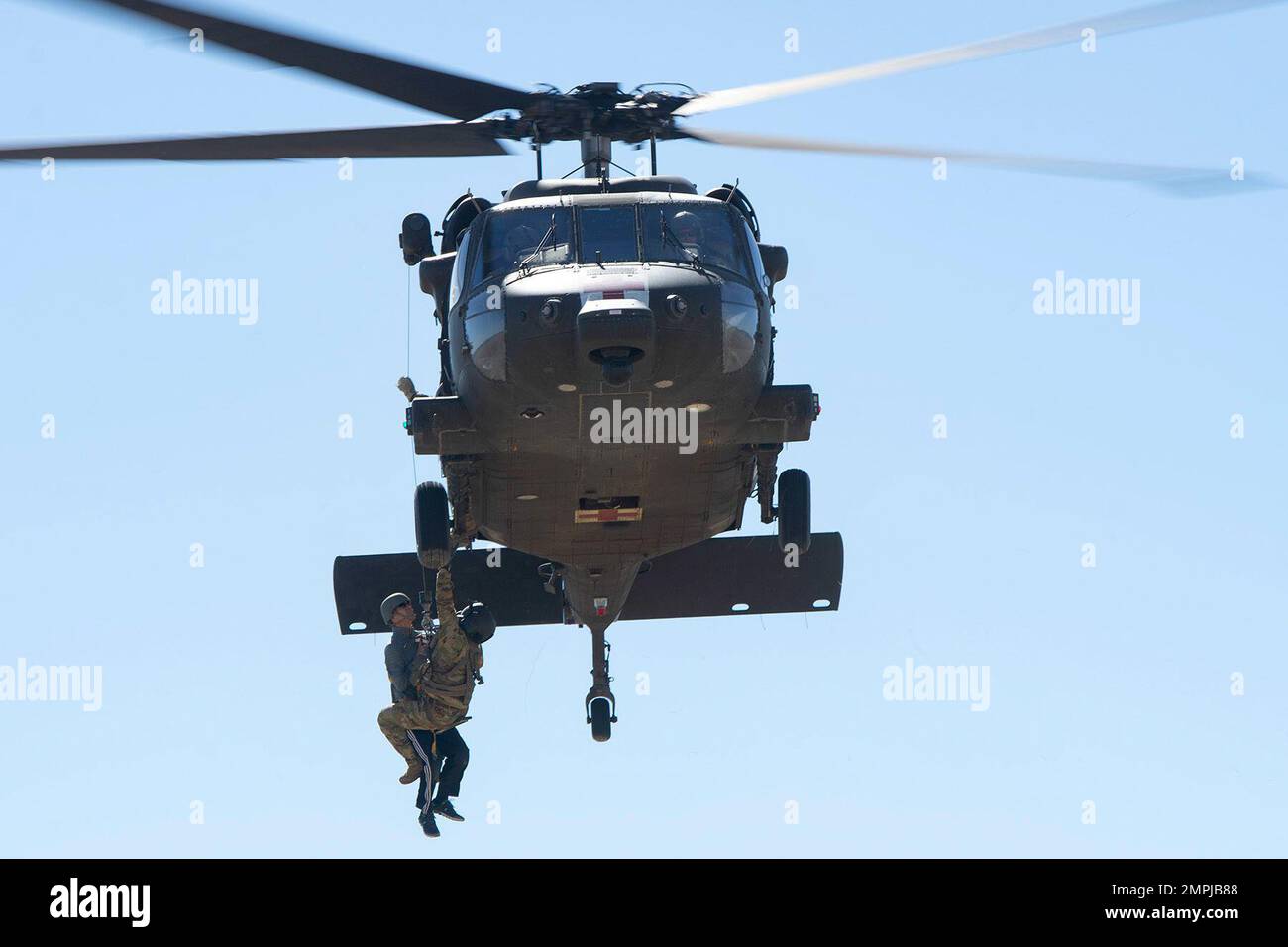 A soldier hoists a participant of 93rd Joint Civilian Orientation ...