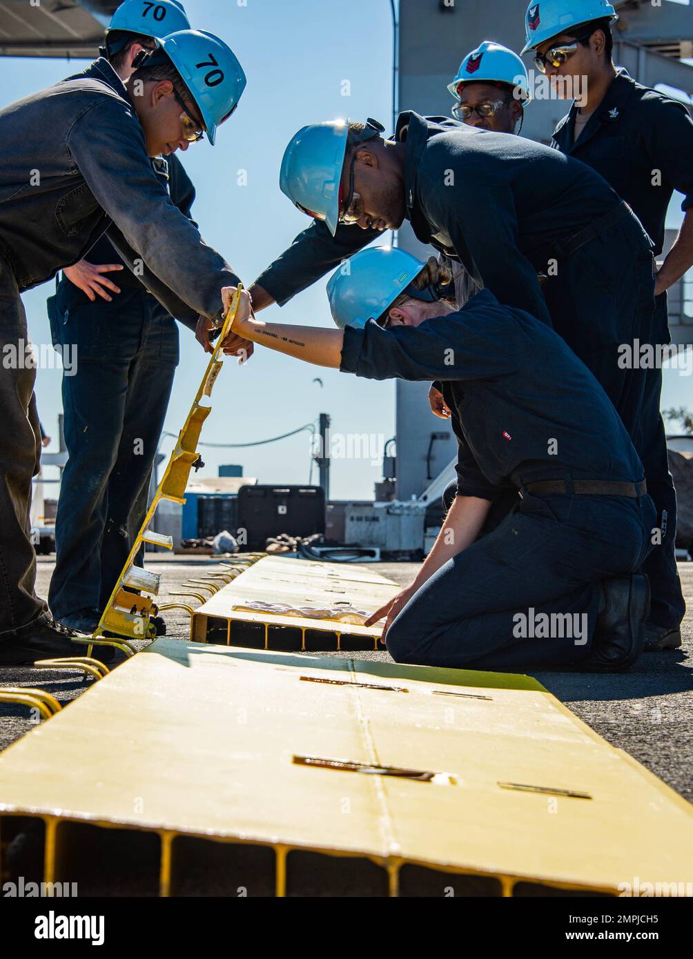 221025-N-AV223-1037 SAN DIEGO (Oct. 25, 2022) Sailors install barricade deck ramps in ...