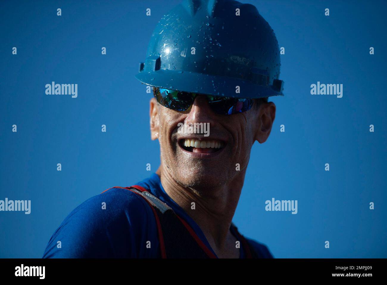 Rob Urbach, chief executive officer of the Iditarod, reacts to a watery ...