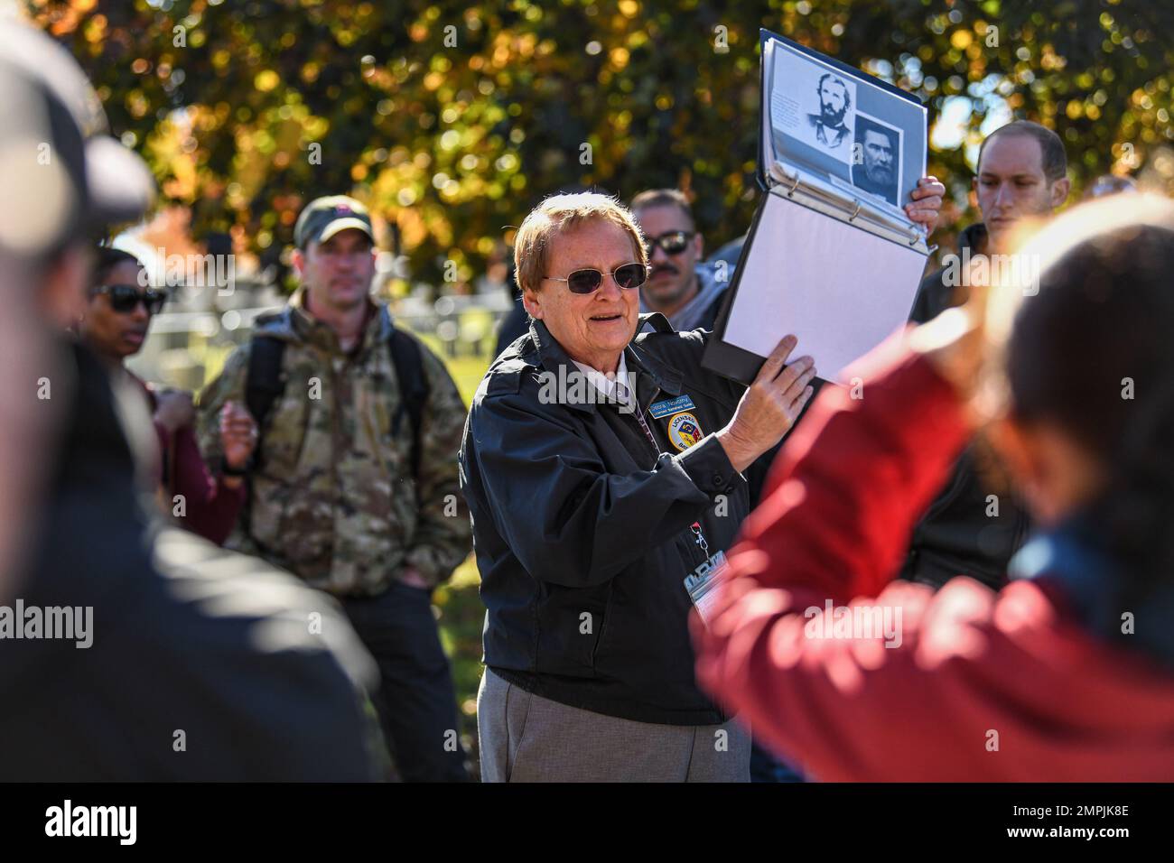 Licensed Battlefield Guide of Evergreen cemetery, Deb Novotny, holds up ...