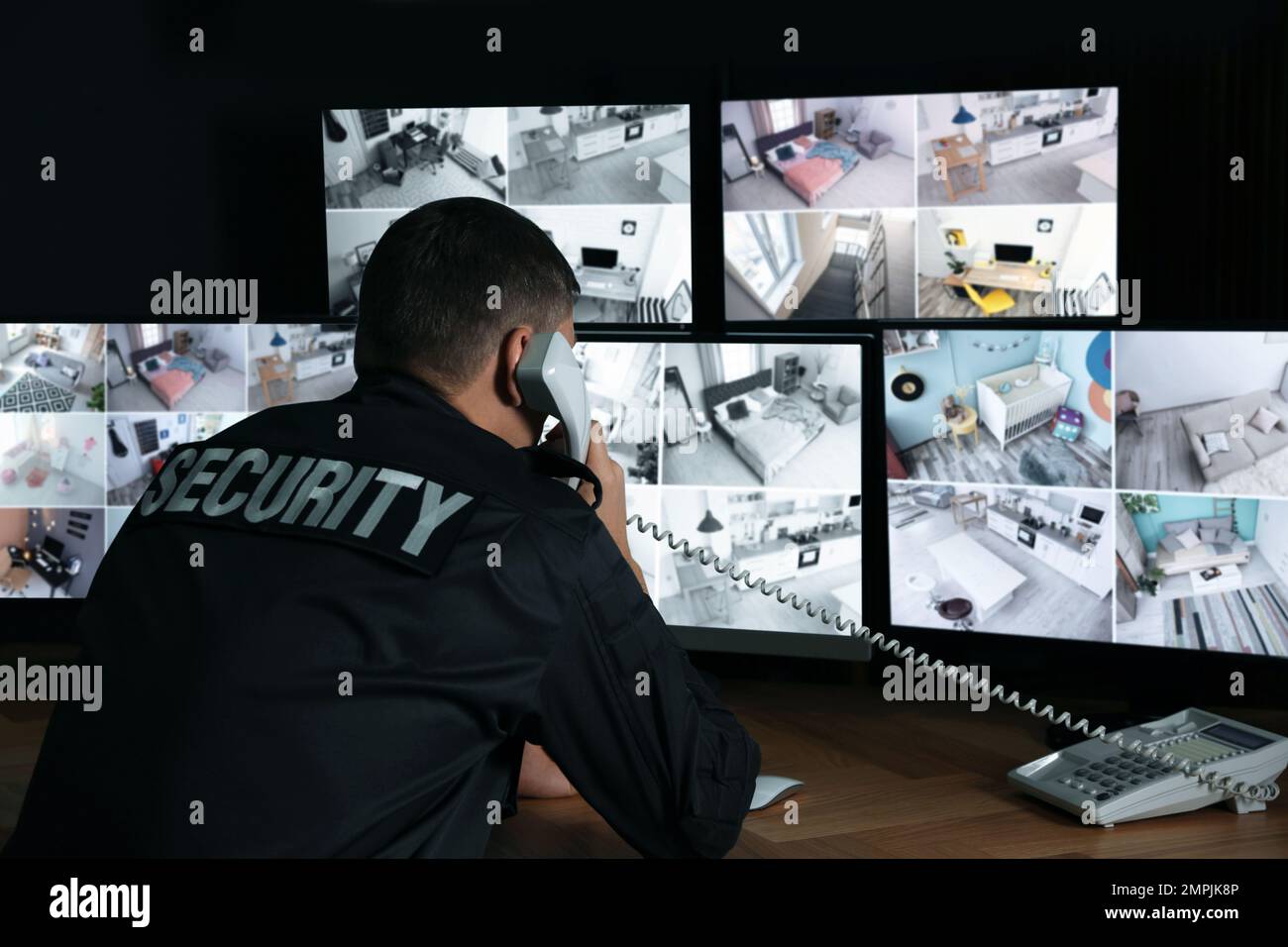 Security guard talking on telephone at workplace Stock Photo - Alamy