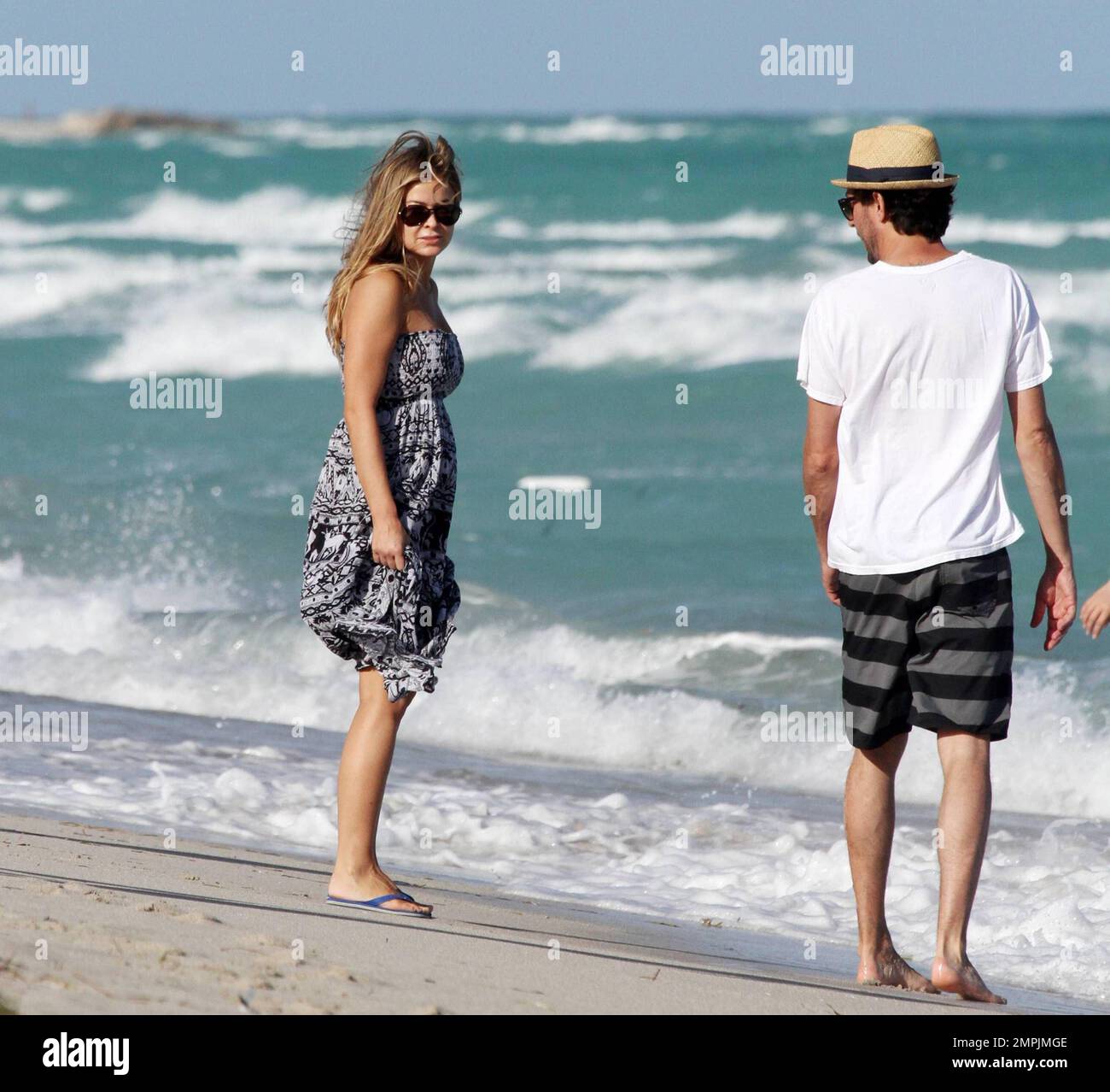 Carmen Electra looks windswept as she takes a stroll on Miami Beach in a sundress. Electra ...