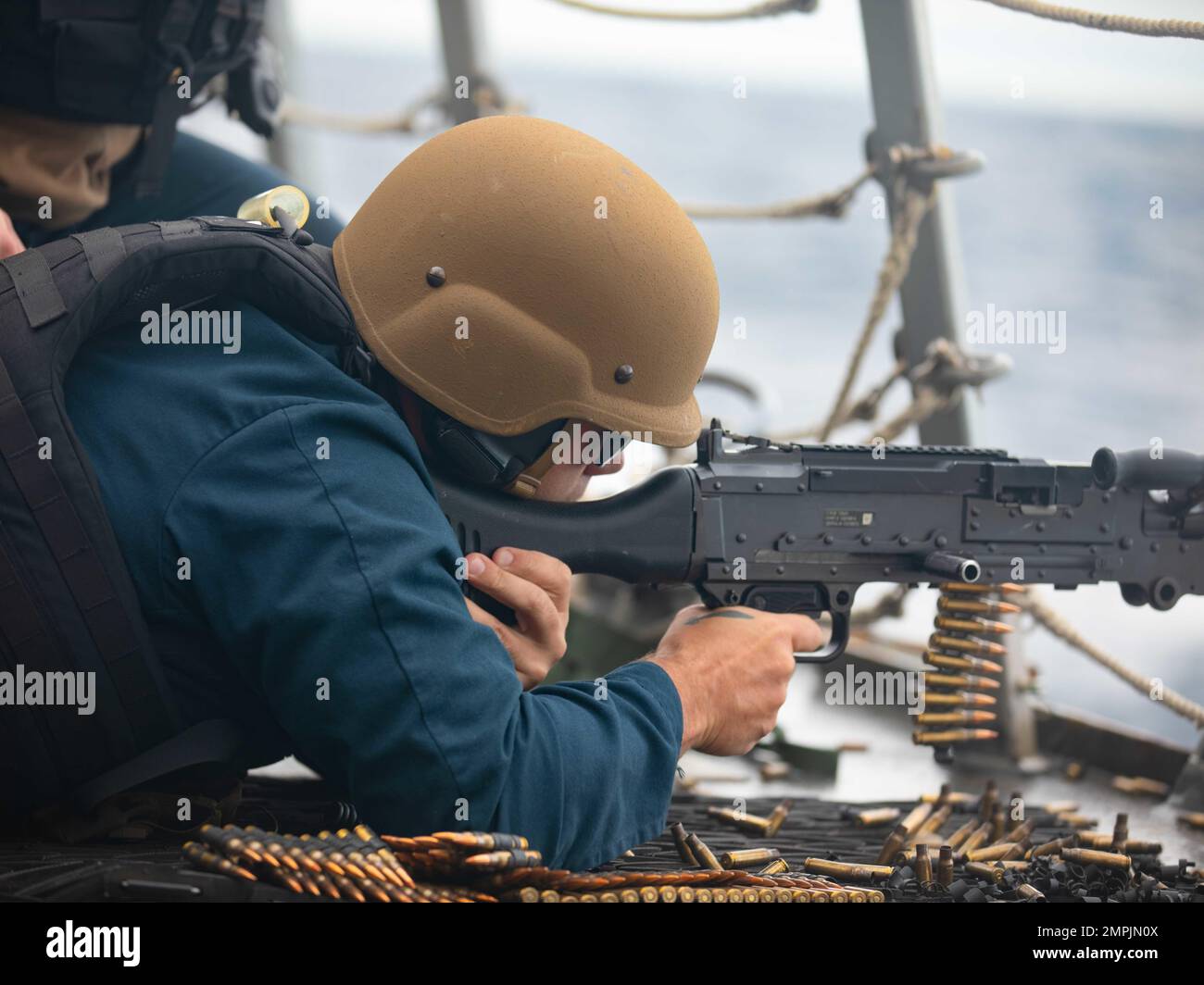 Gunner's Mate 1st Class Ryan Scott fires a M .240 Bravo medium machine ...