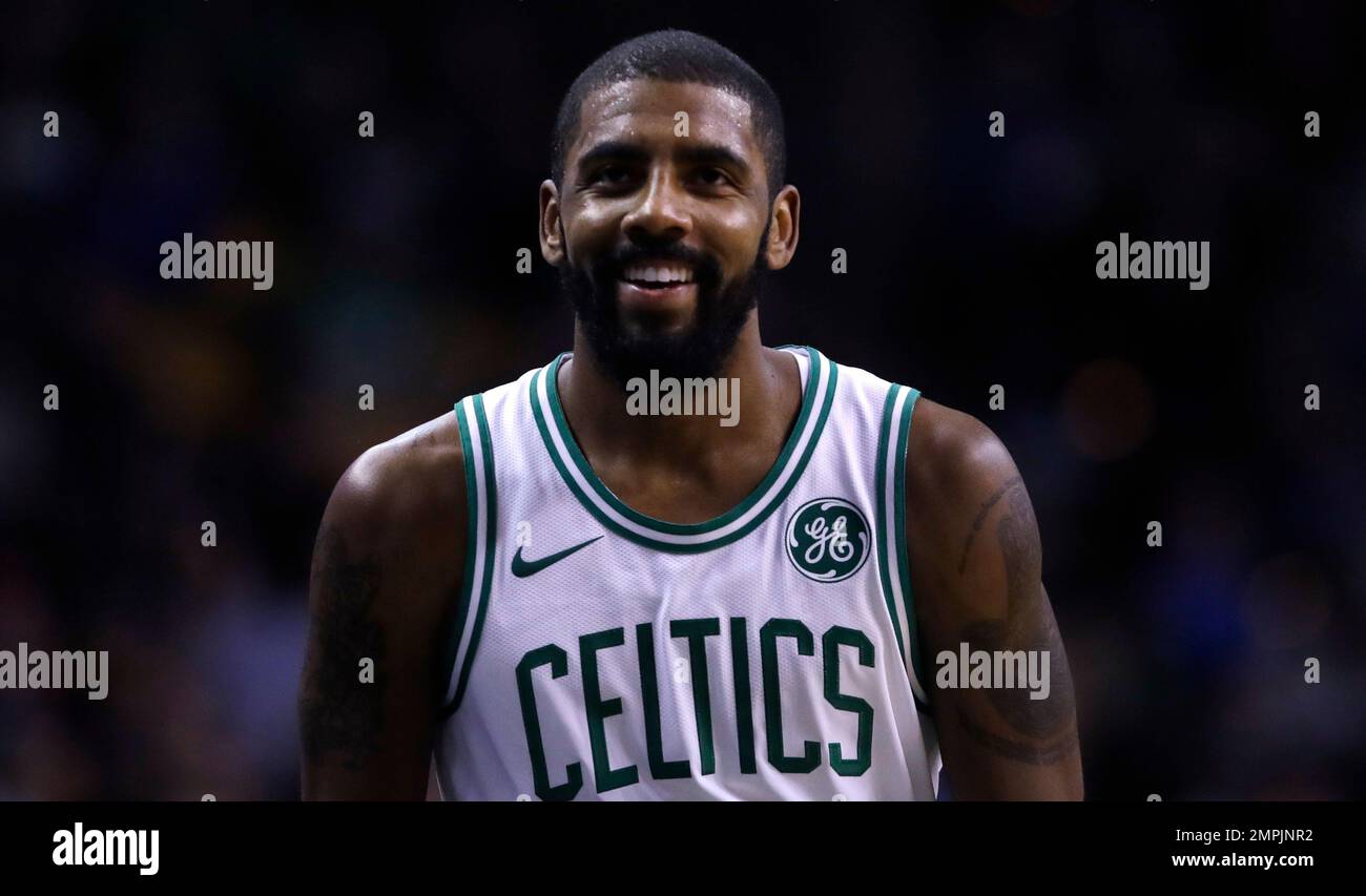 Boston Celtics guard Kyrie Irving smiles during the first quarter of an ...