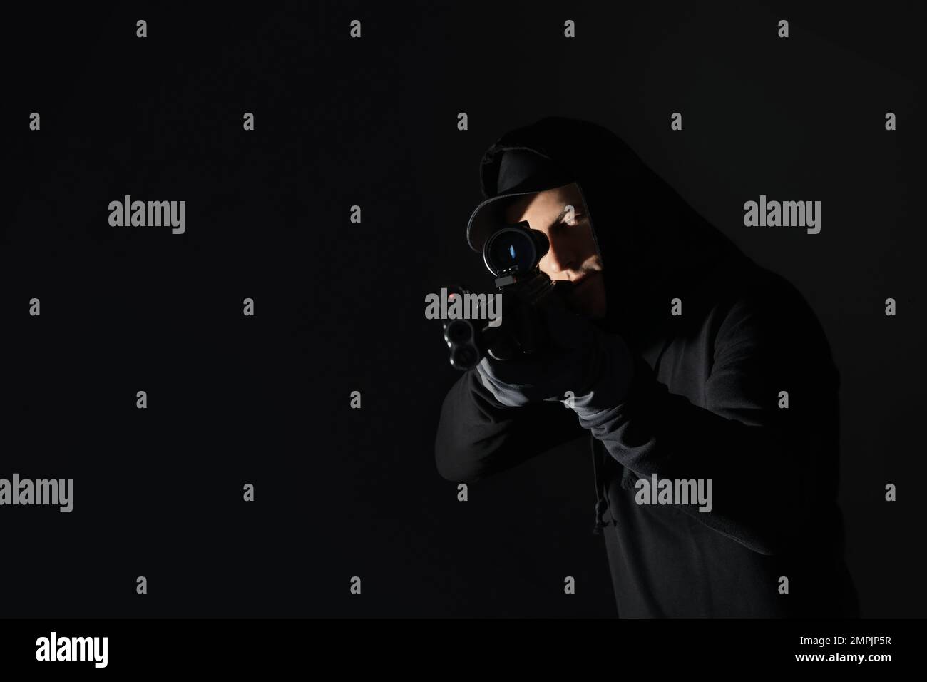 Professional killer with sniper rifle on black background Stock Photo ...
