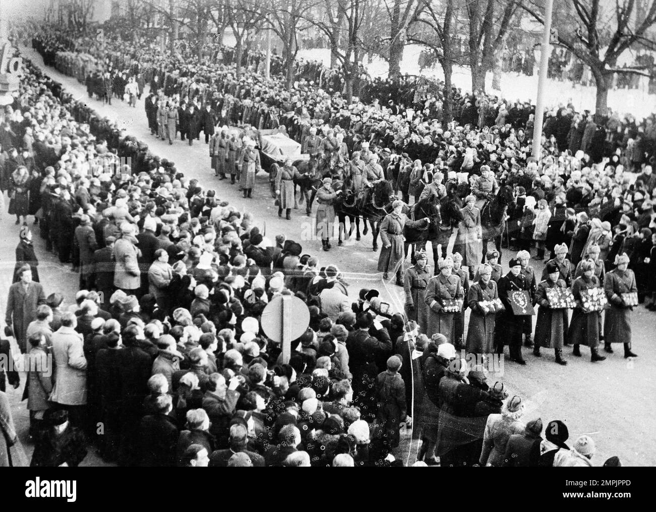 A line of men, bottom right, carry the many civil and military awards ...