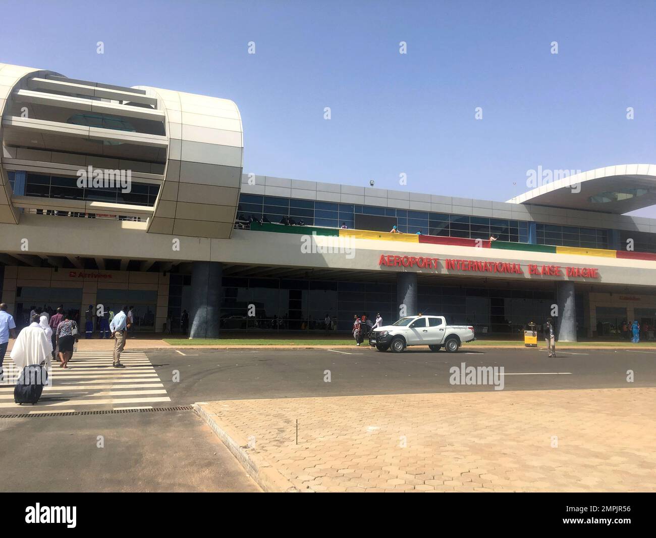 Passengers walk towards the arrival hall of the new Airport ...