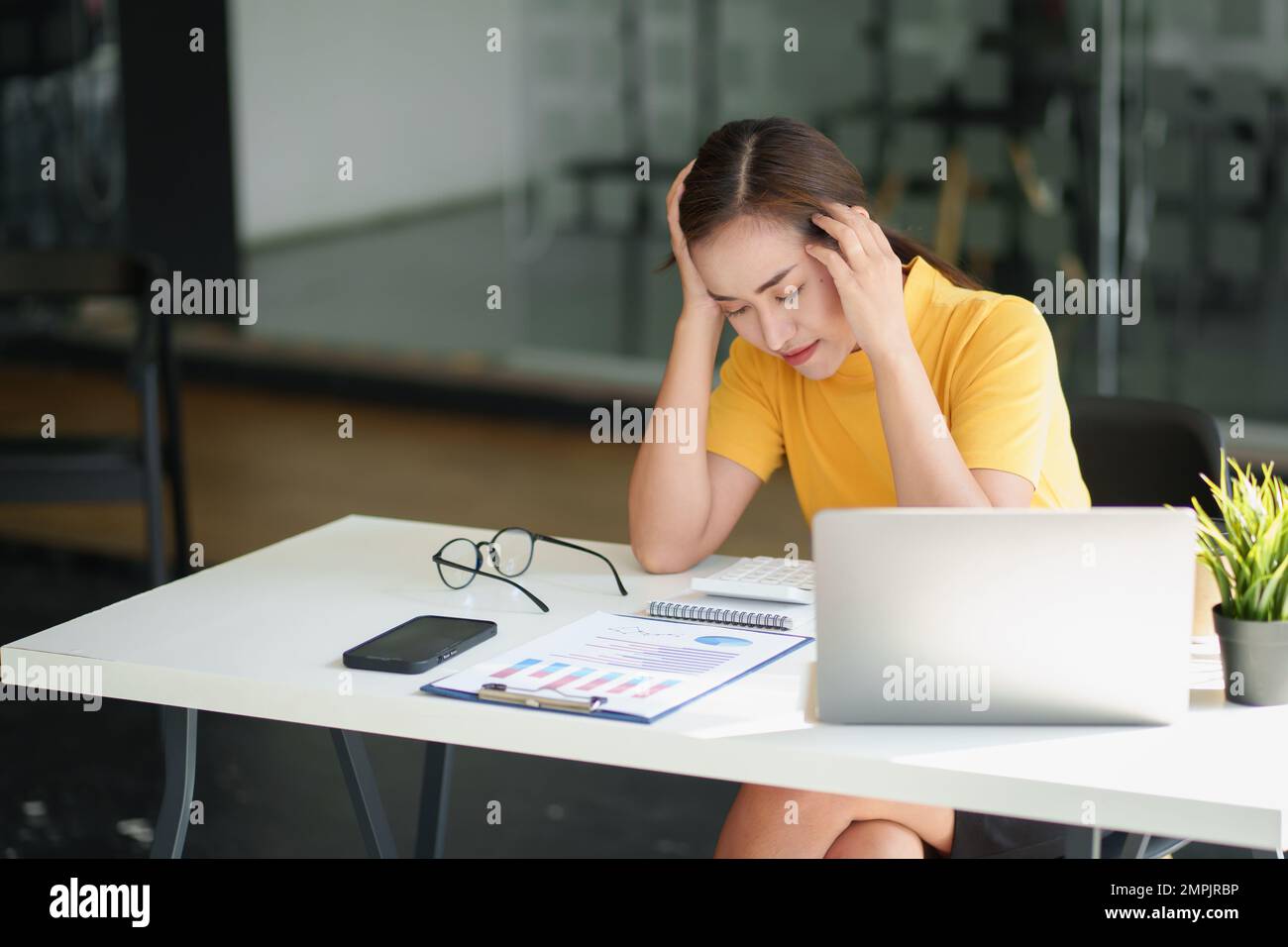 Asian business woman worry about marketing plan of this years. Finance ...