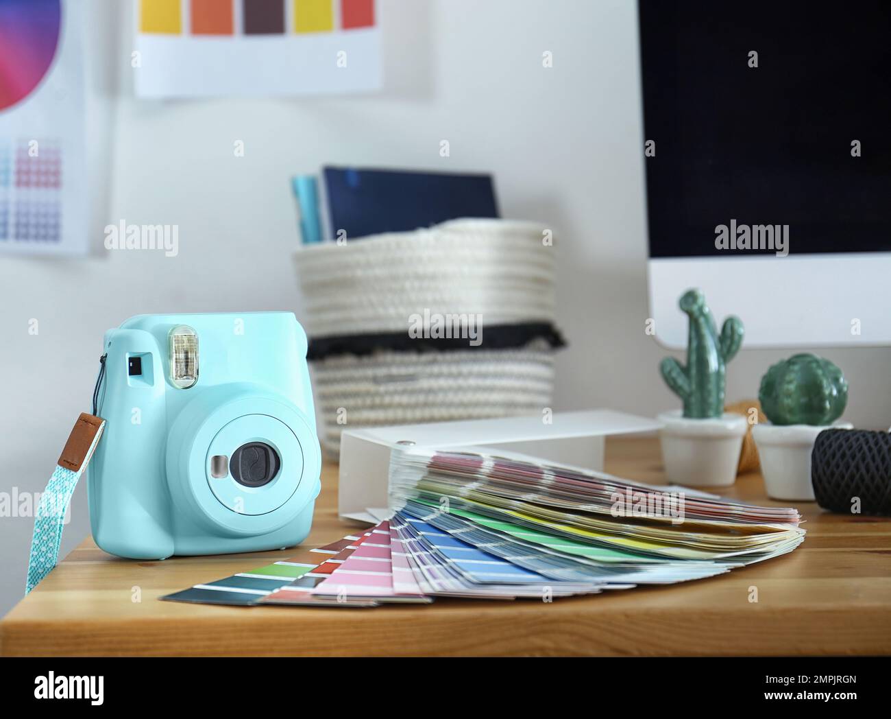 Digital camera and color palette on table in studio. Modern designer's ...