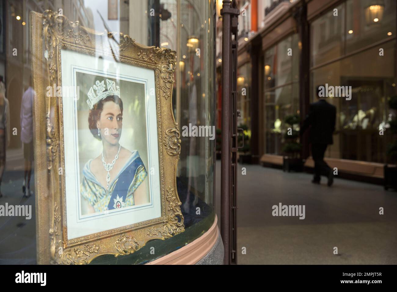 A portrait of Queen Elizabeth II is displayed in a shop window in ...