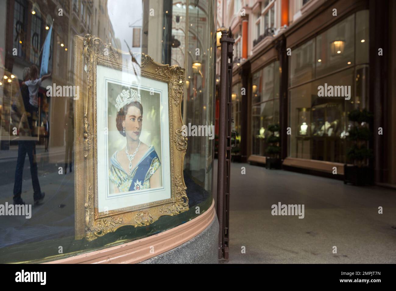 A portrait of Queen Elizabeth II is displayed in a shop window in ...