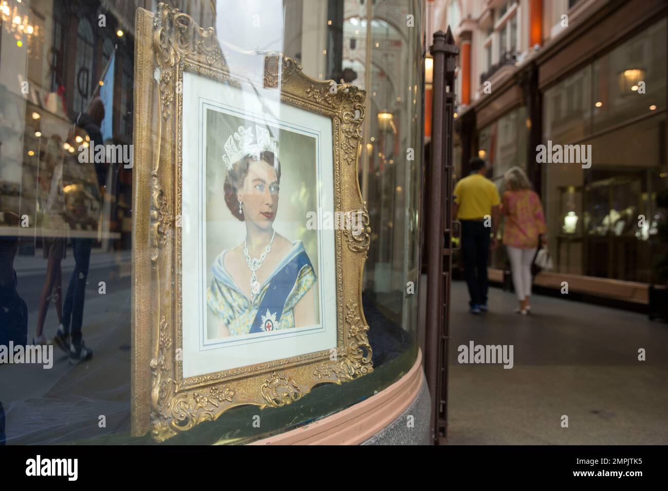 A portrait of Queen Elizabeth II is displayed in a shop window in ...