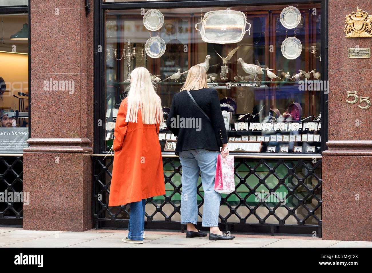 A portrait of Queen Elizabeth II is displayed in a shop window in ...